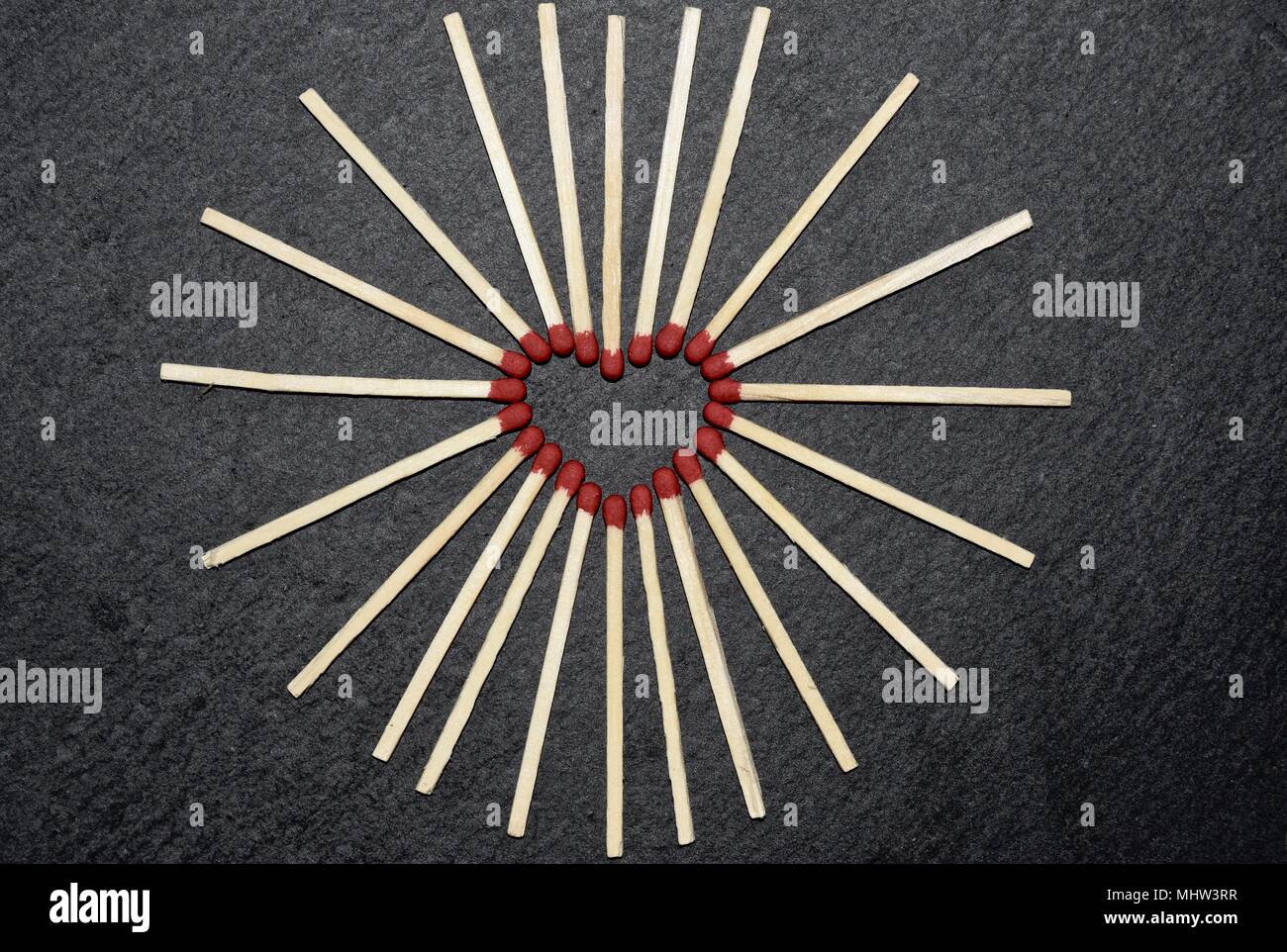 Collection of red head matches laid out in a heart forming shape on a ...