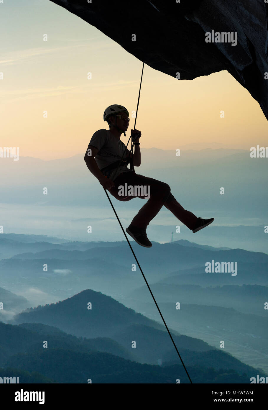 Man rolling rock up hill hi-res stock photography and images - Alamy