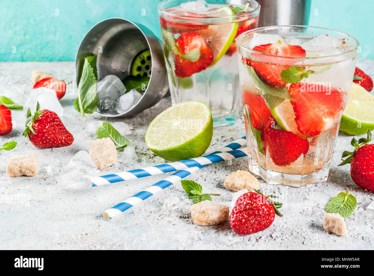 Summer refreshment drink, strawberry mojito cocktail on light concrete ...
