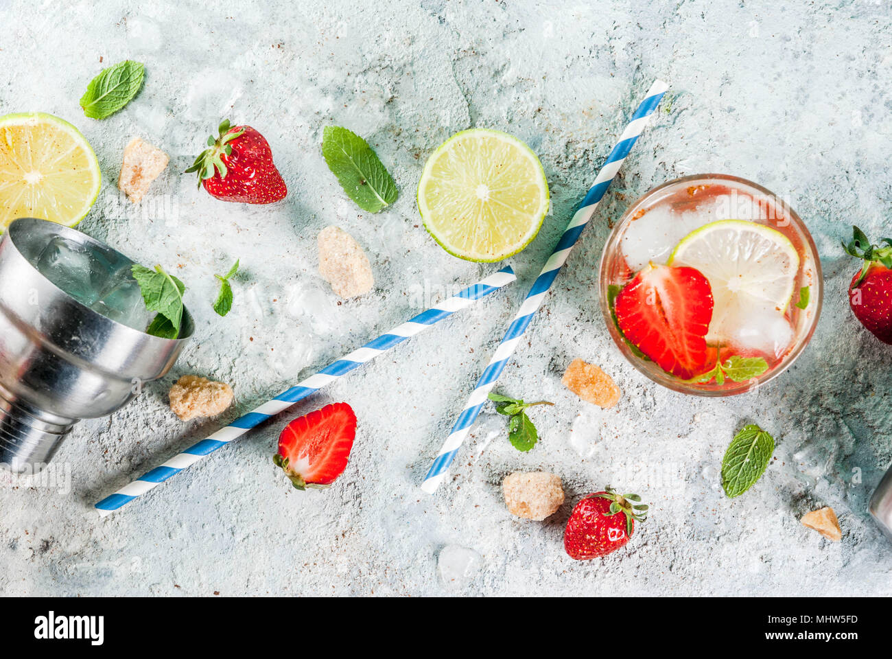 Summer refreshment drink, strawberry mojito cocktail on light concrete ...