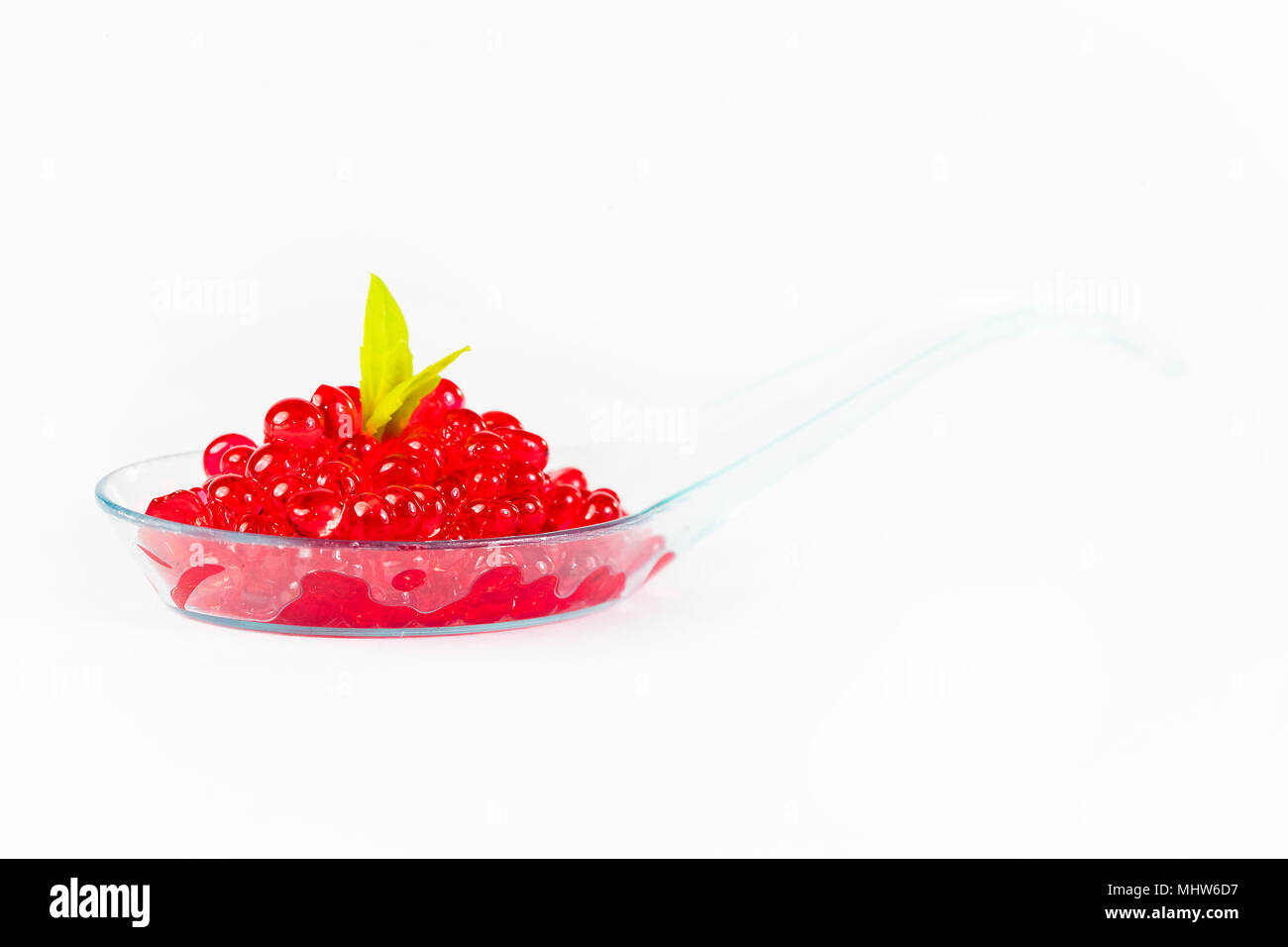 Plastic spoons with fish caviar on a white background Stock Photo - Alamy