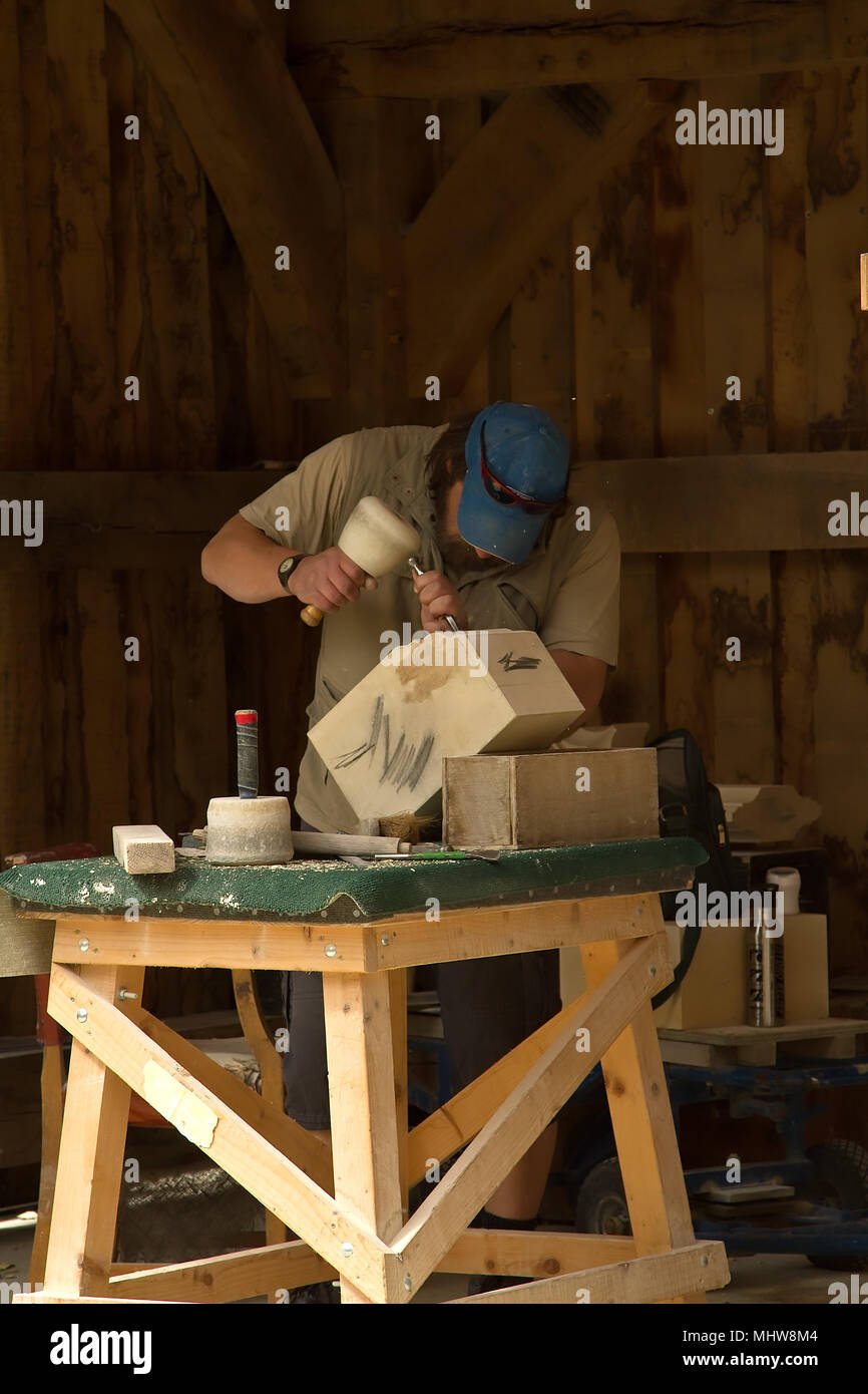 A stonemason works on a block of stone for repair work to Yorkminster ...