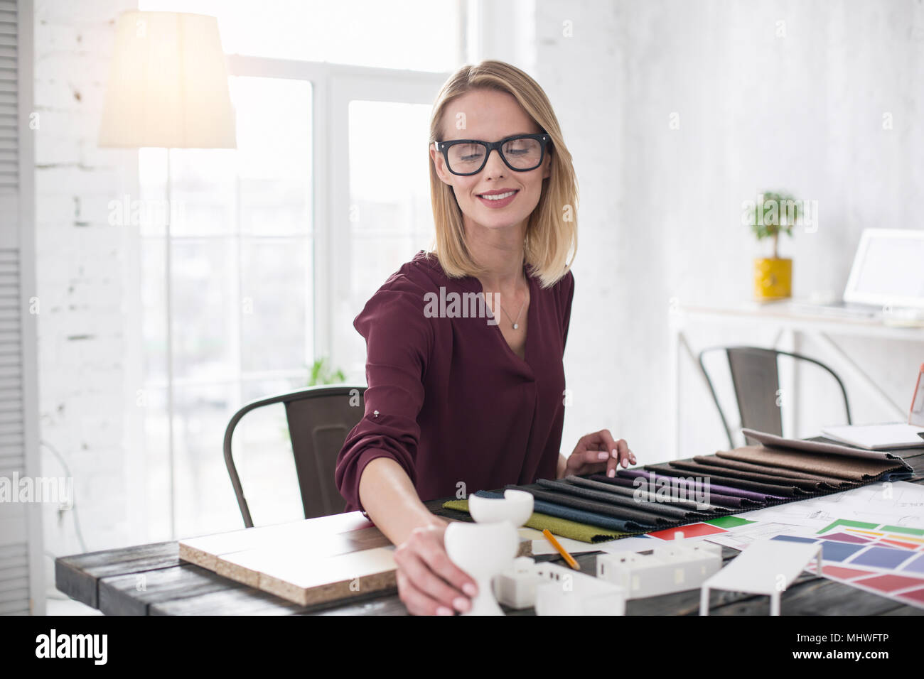 Pensive female designer working on design Stock Photo - Alamy