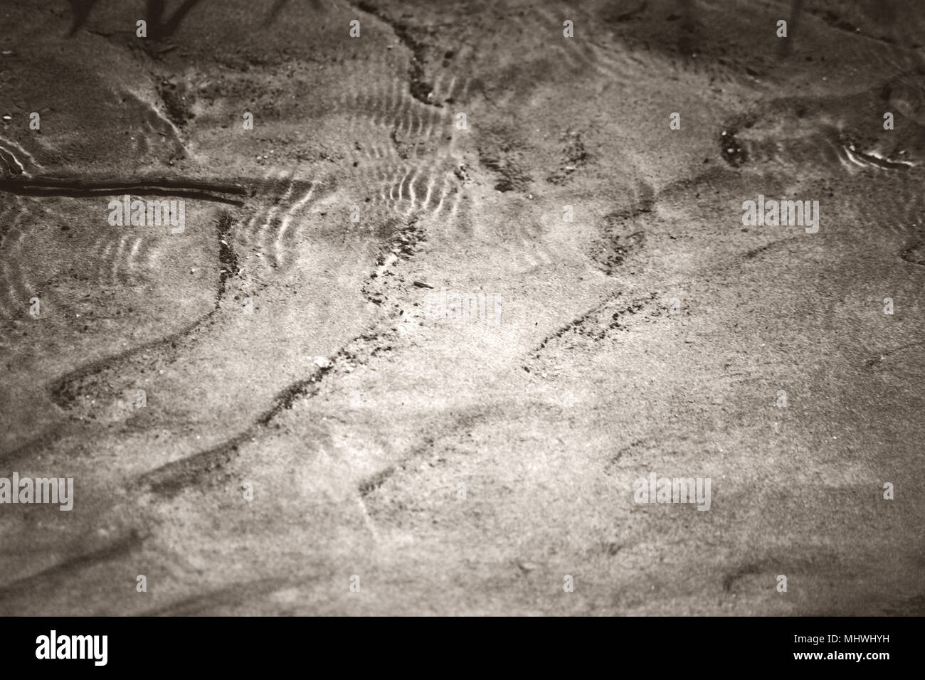 Currents of water over a sandbar of fine sand Stock Photo - Alamy