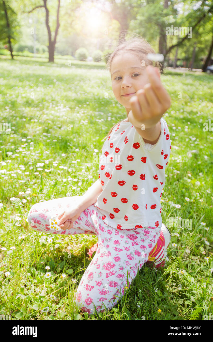 Happy little girl playing in nature at flower meadow, beautiful spring ...