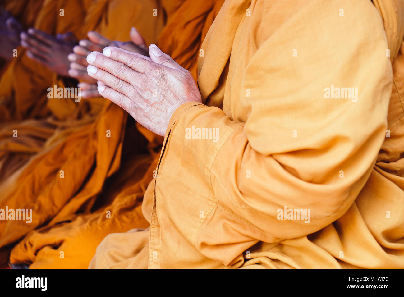 Buddhist monks praying Stock Photo - Alamy