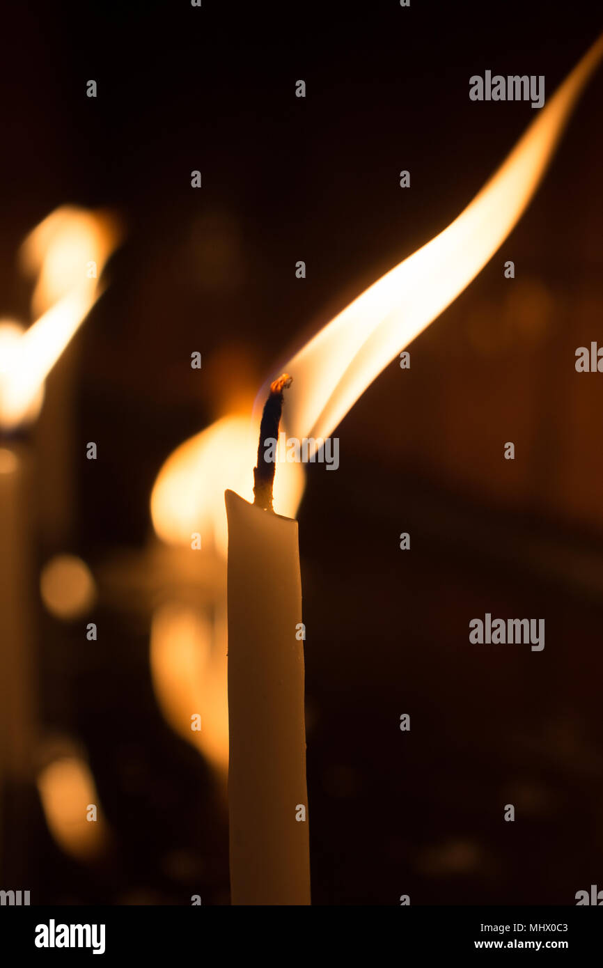 Burning candles with candle light in the dark Stock Photo - Alamy