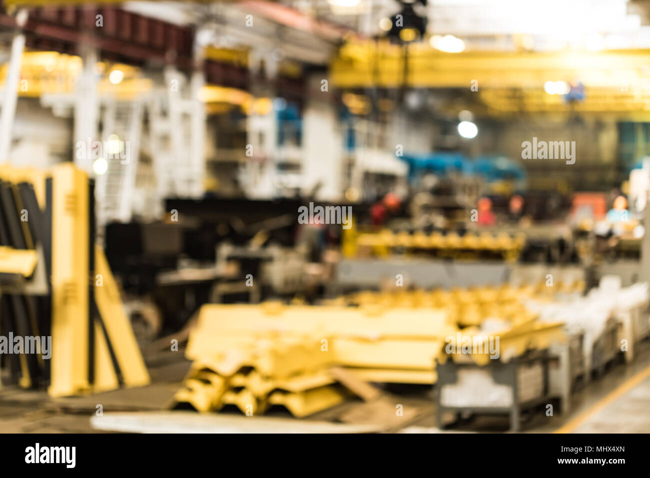 Defocused image of assembly room at big industrial plant manufacturing ...