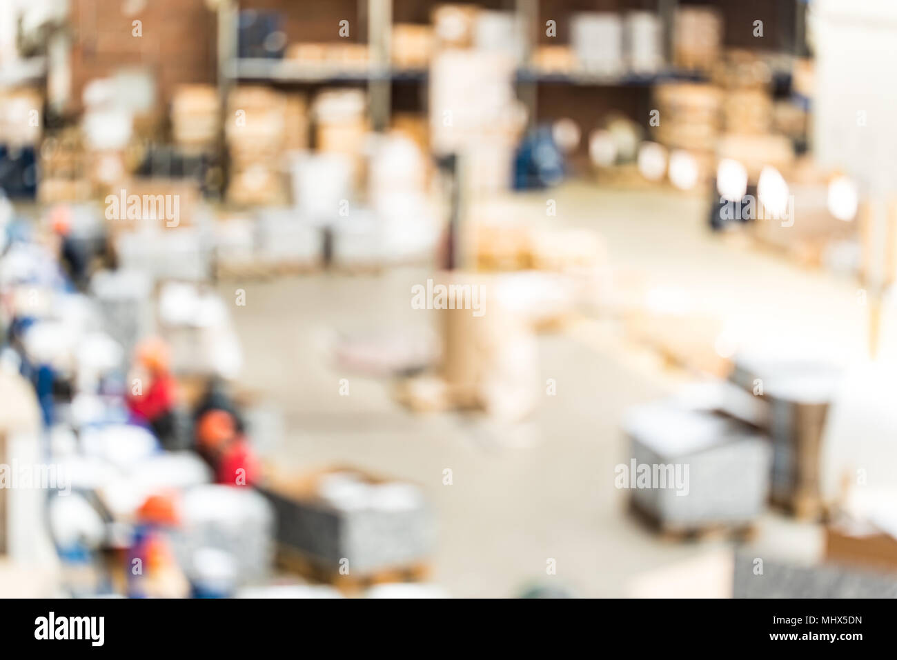 Defocused image of tiered storage facility at machinery industrial ...