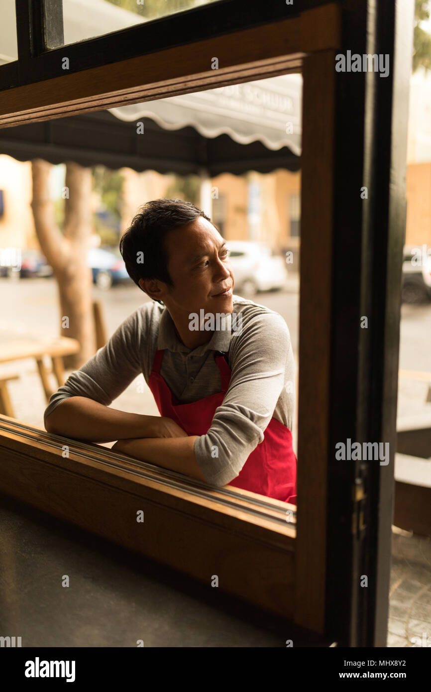 Staff looking backward near a window Stock Photo - Alamy