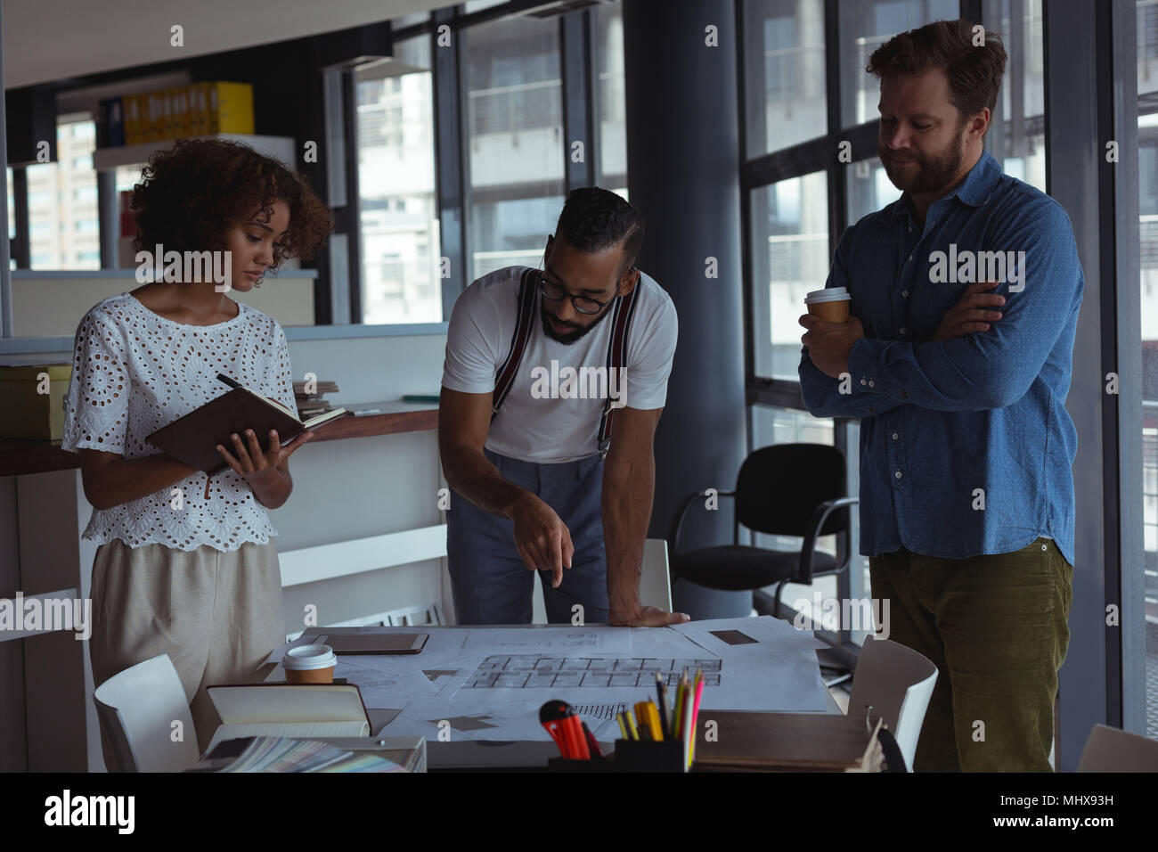 Architects discussing over blueprint Stock Photo - Alamy