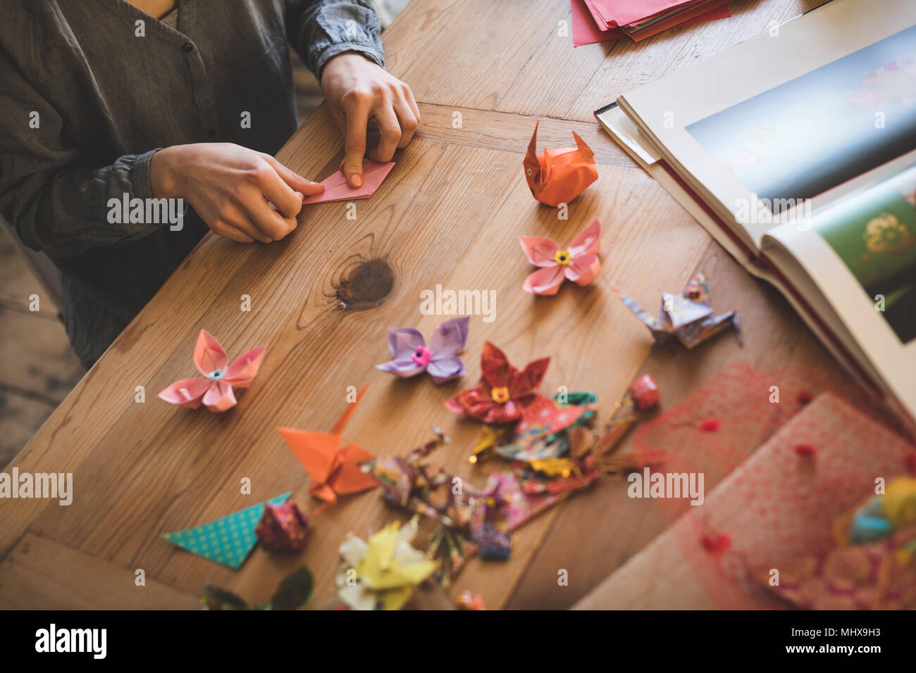 Woman folding paper origami hi-res stock photography and images - Alamy