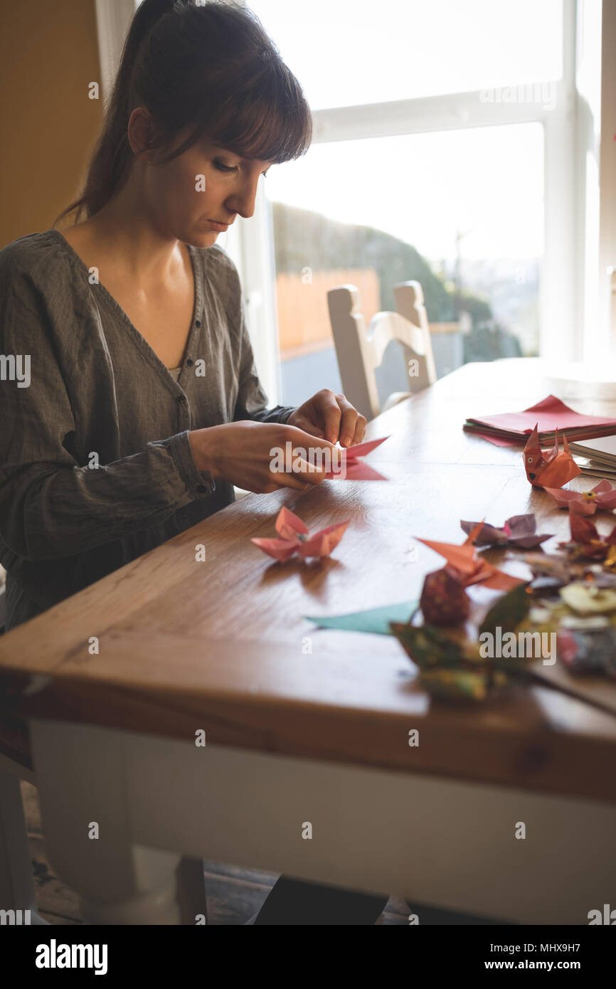 Woman folding paper origami hi-res stock photography and images - Alamy