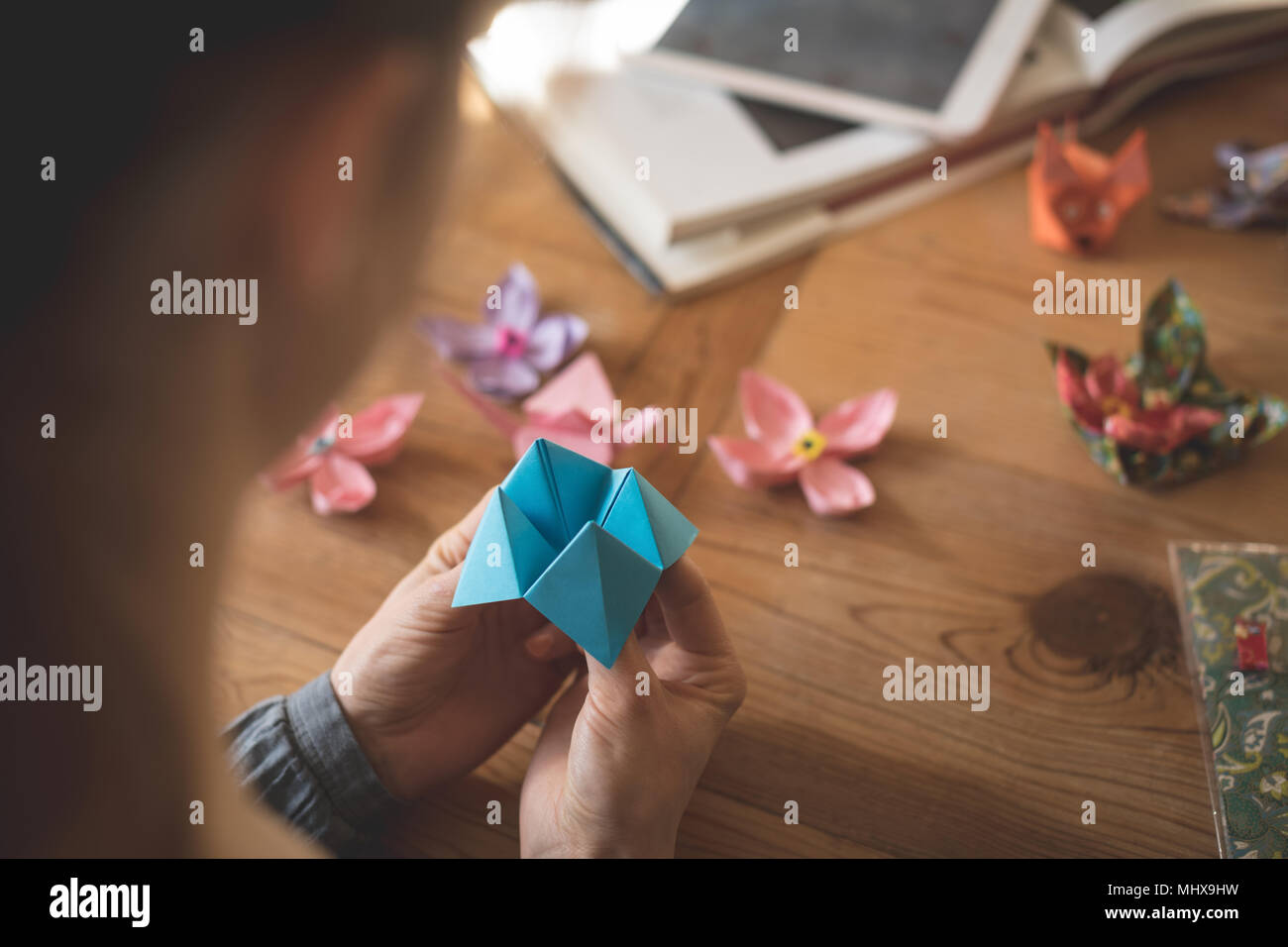 Woman folding paper origami hi-res stock photography and images - Alamy