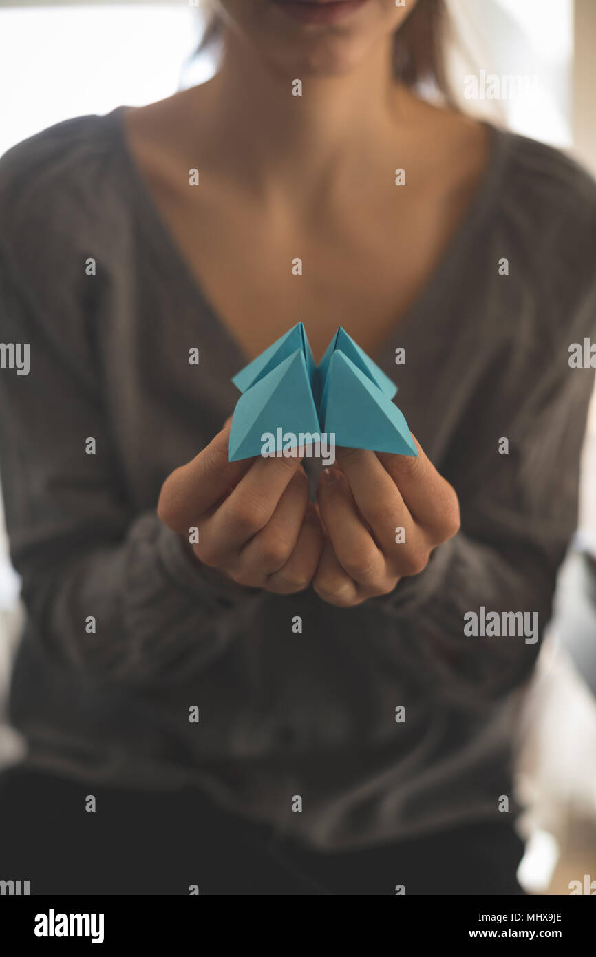 Woman showing origami at home Stock Photo - Alamy