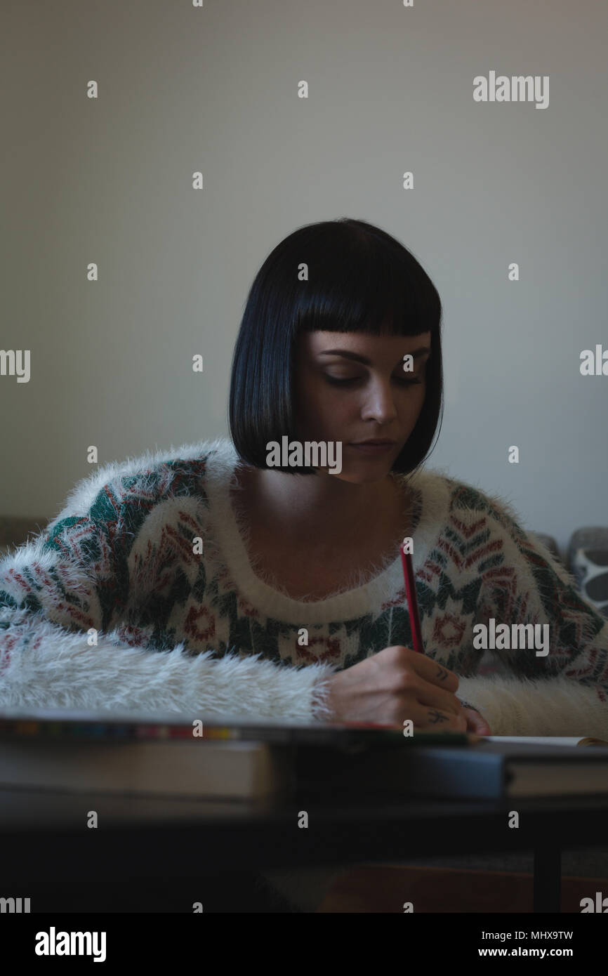 Woman writing book sofa hi-res stock photography and images - Alamy