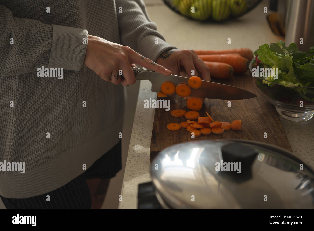 Woman cutting vegetables in kitchen Stock Photo - Alamy
