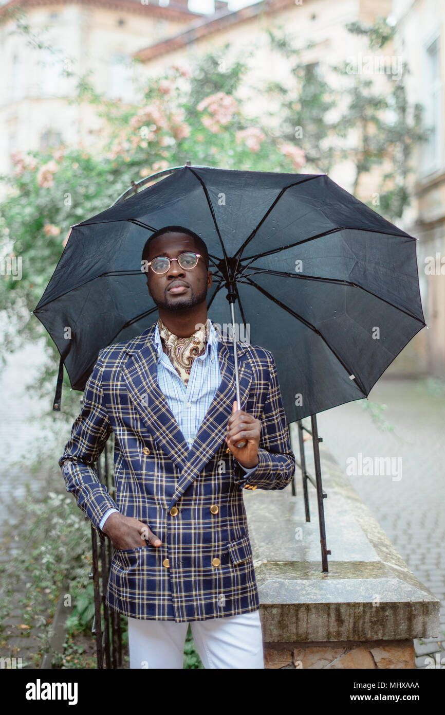 Street portrait man in city with umbrella Stock Photo - Alamy