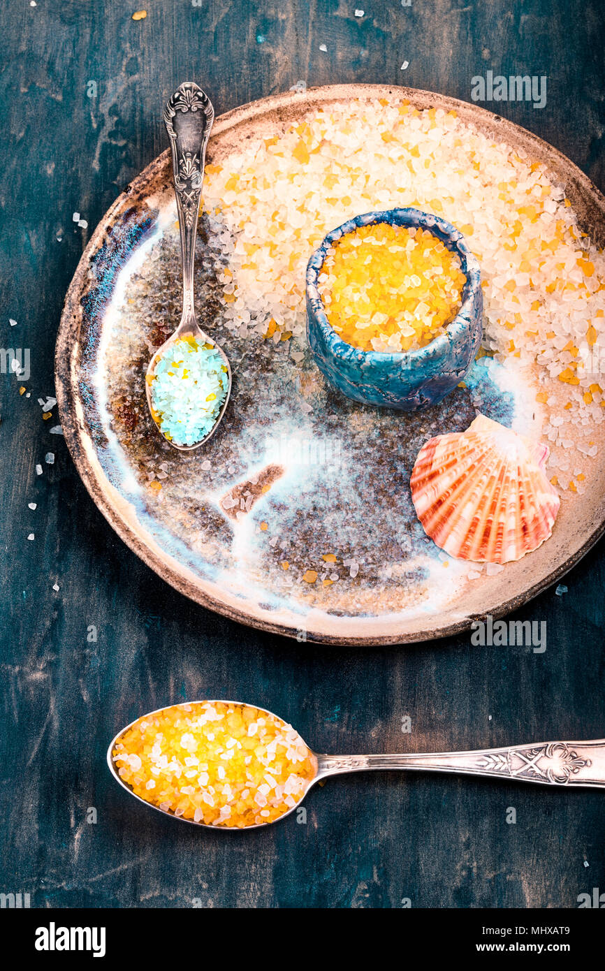 Colorful sea salt in bowl and spoons put on old pottery plate. Photo ...