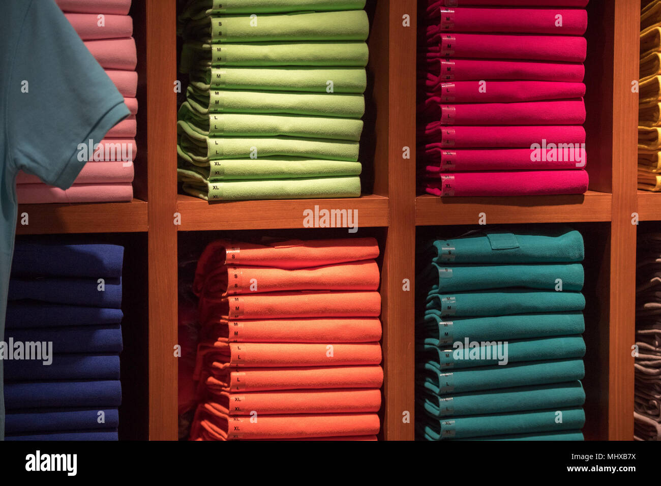 different colors polo shirt on display stand Stock Photo - Alamy