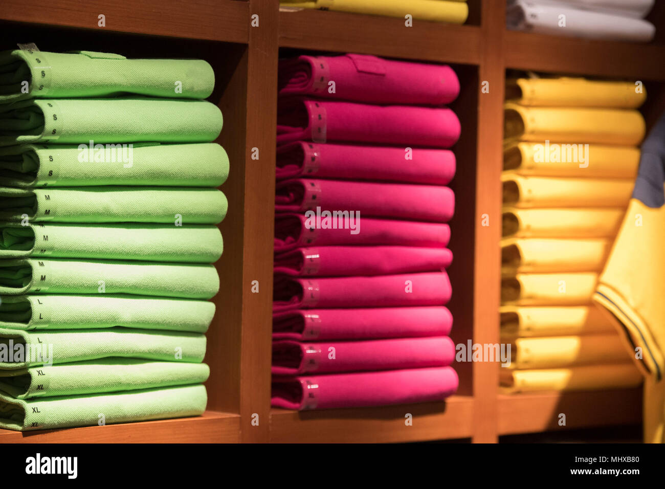 different colors polo shirt on display stand Stock Photo - Alamy
