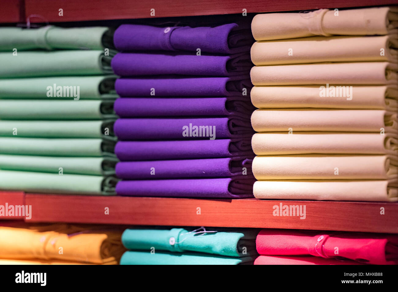 different colors polo shirt on display stand Stock Photo - Alamy