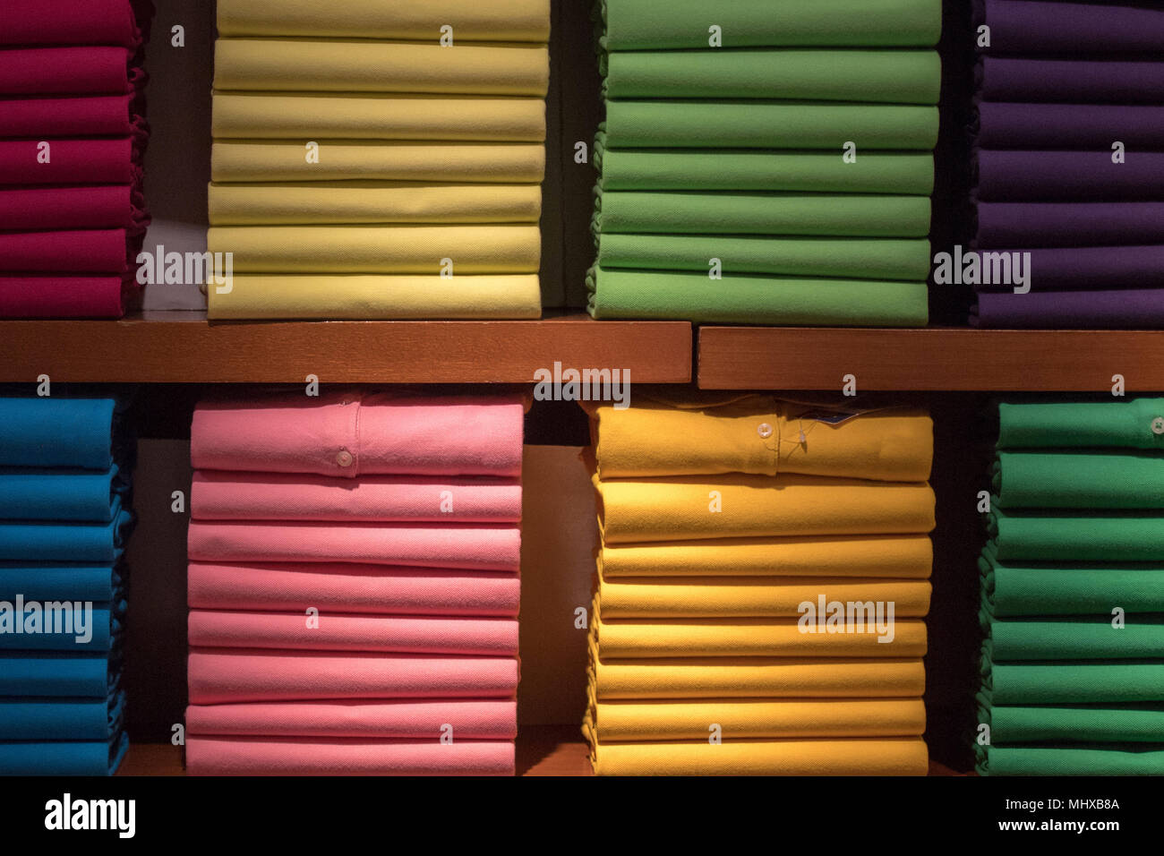 different colors polo shirt on display stand Stock Photo - Alamy