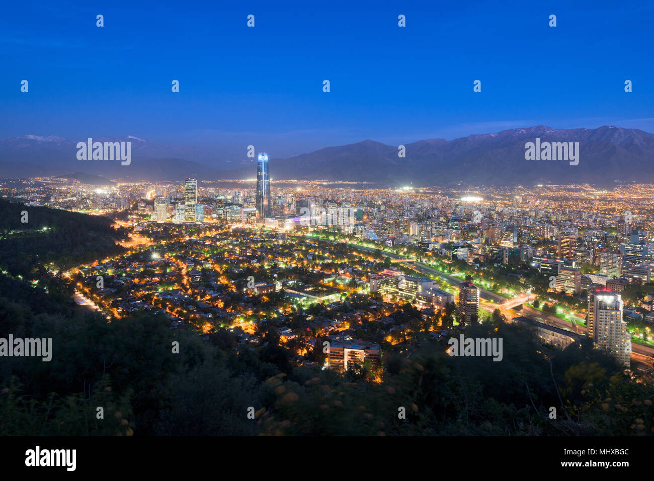 Panoramic view at night of Santiago de Chile with The Andes Mountain ...