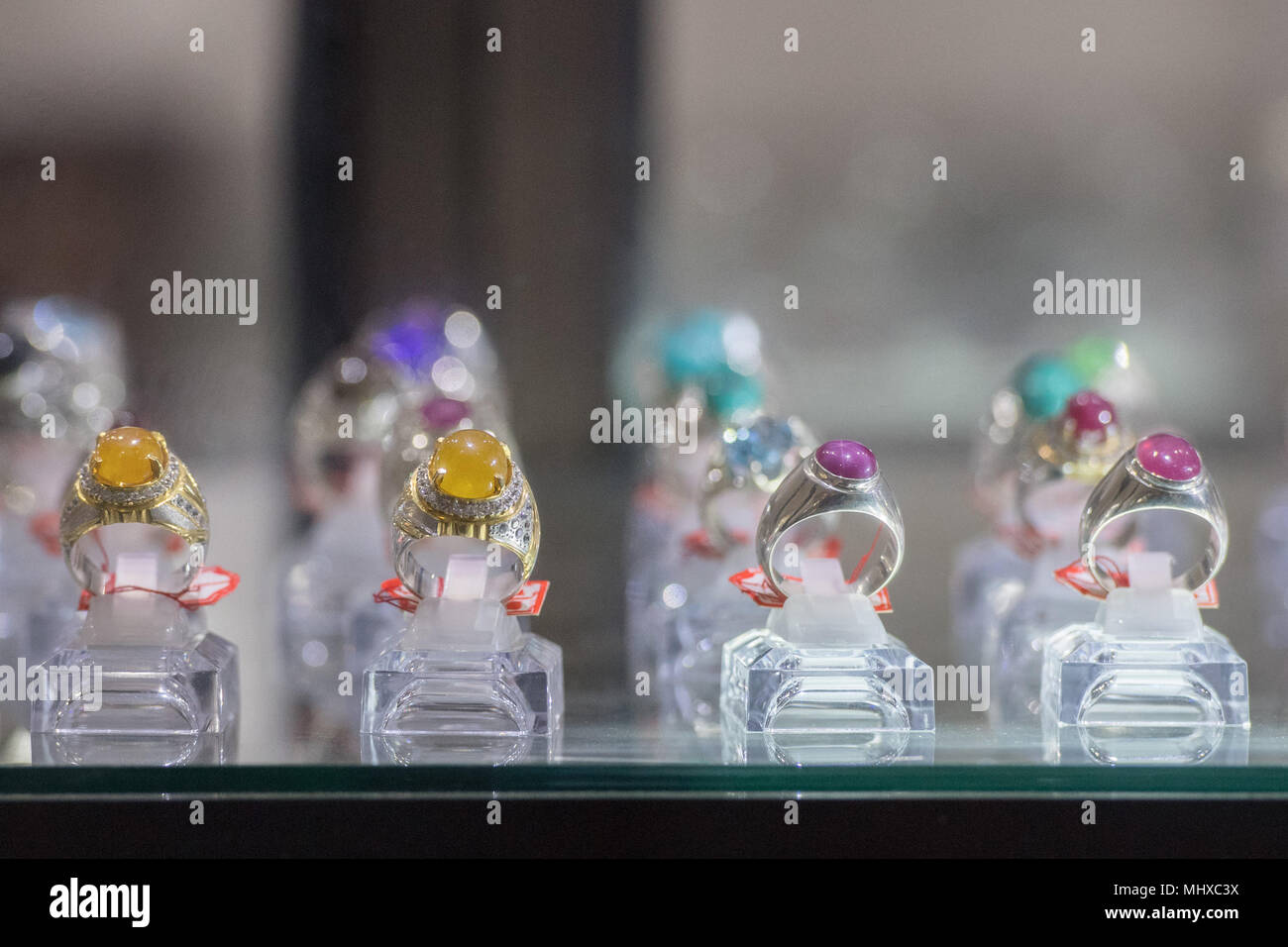 hand made silver rings on display stand for sale asian style Stock ...