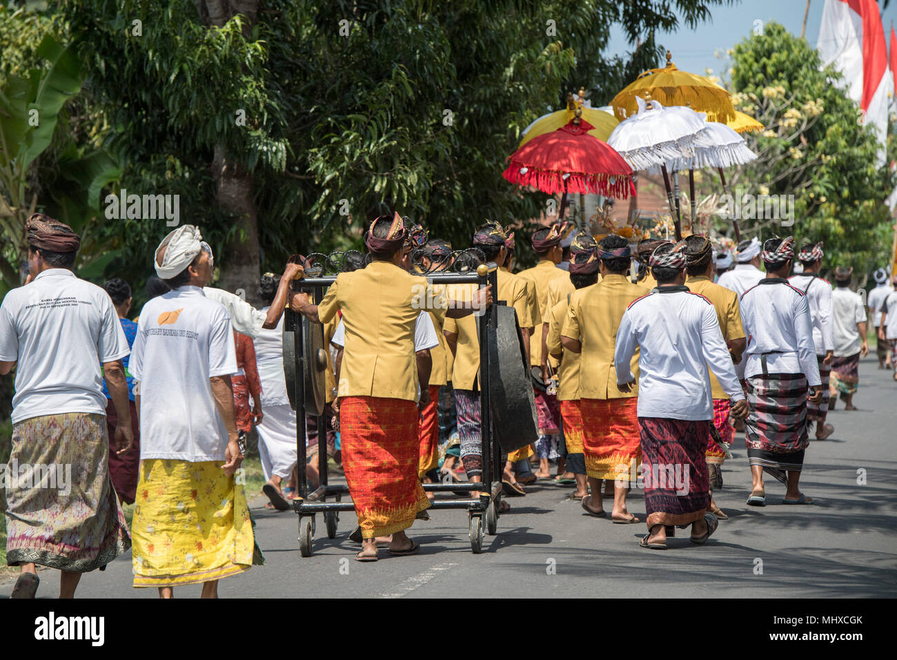 BALI, INDONESIA - AUGUST 17, 2016 - Balinese monk and worshipper with ...
