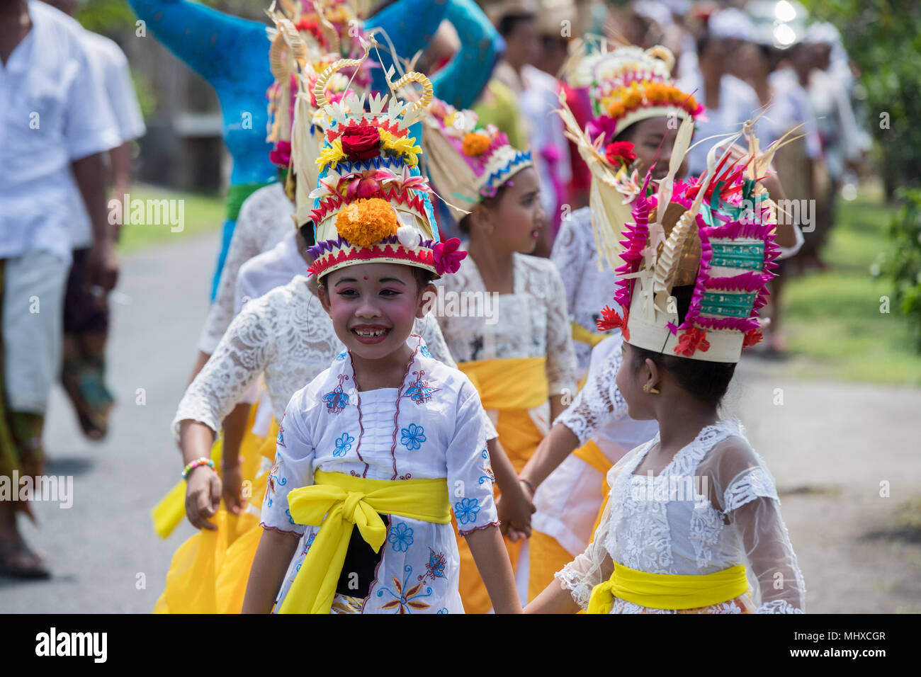 BALI, INDONESIA - AUGUST 17, 2016 - Balinese monk and worshipper with ...