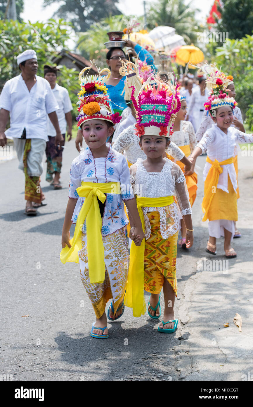 BALI, INDONESIA - AUGUST 17, 2016 - Balinese monk and worshipper with ...