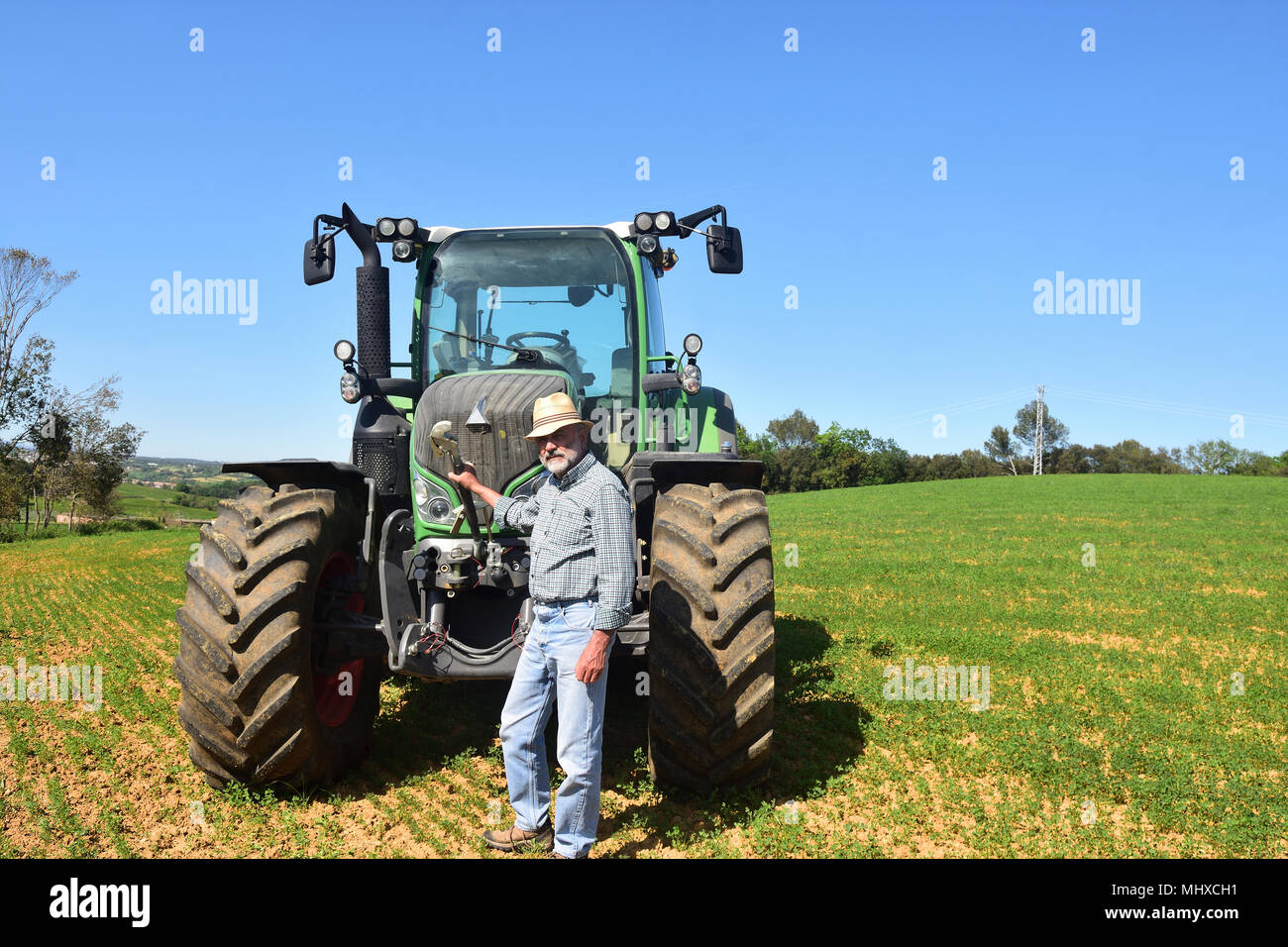 portrait of a farmer man and tractor on the field Stock Photo - Alamy
