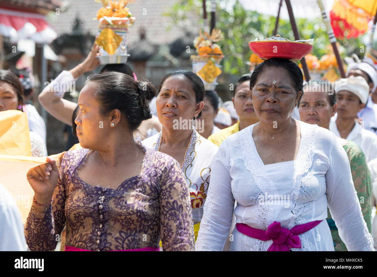 BALI, INDONESIA - AUGUST 17, 2016 - Balinese monk and worshipper with ...
