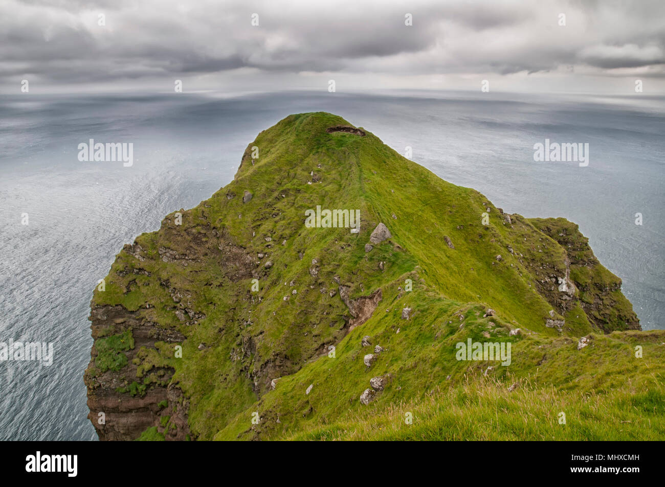 Faer Oer Island view on cloudy background Stock Photo - Alamy
