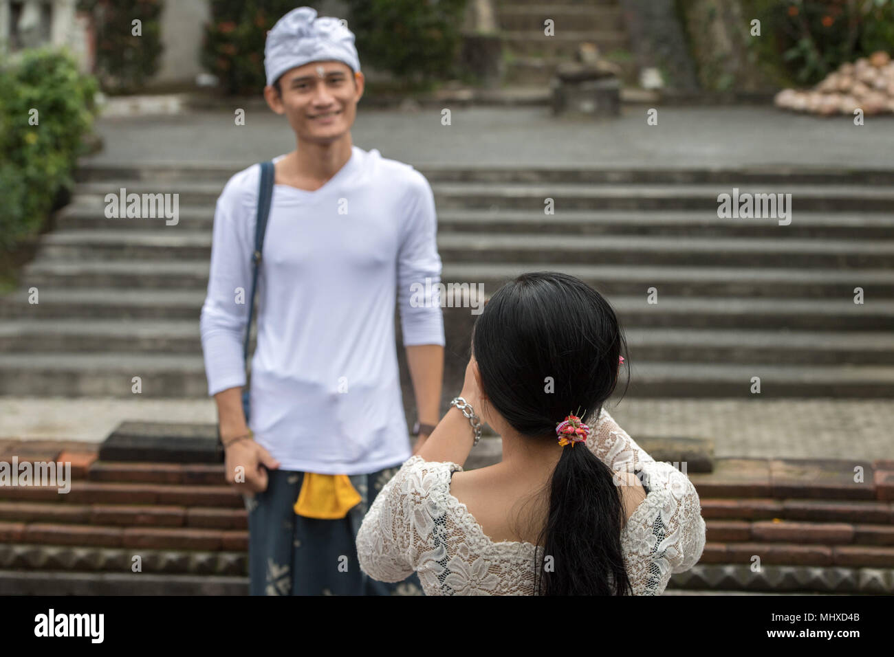 BALI, INDONESIA - AUGUST 17, 2016 - Balinese monk and worshipper with ...