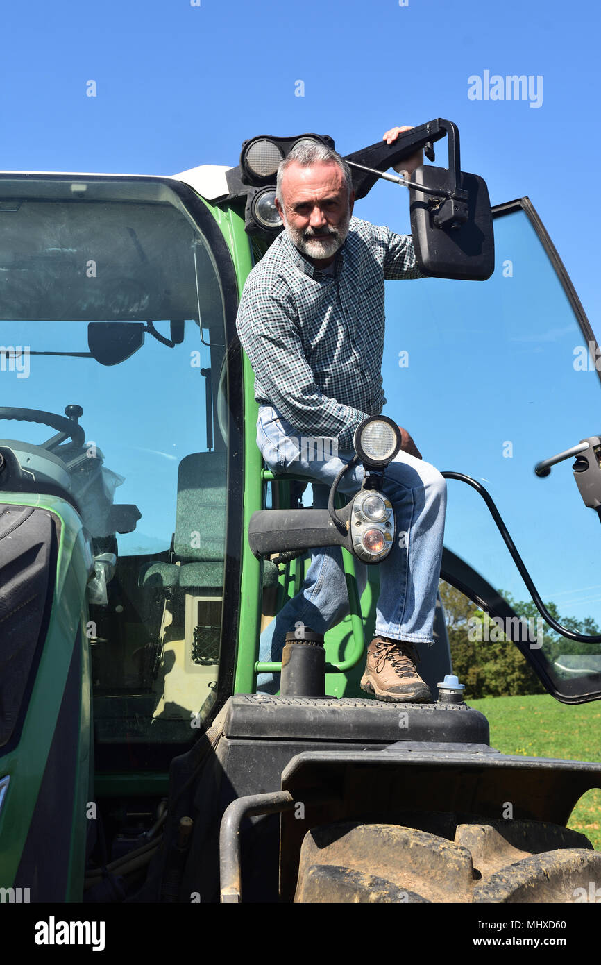 portrait of a farmer man and tractor Stock Photo - Alamy