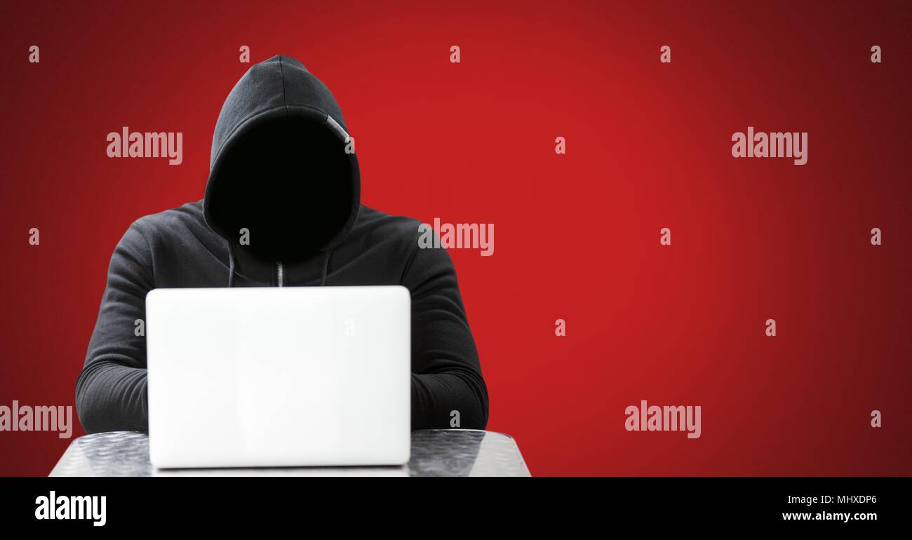 hacker on laptop with red danger background Stock Photo - Alamy