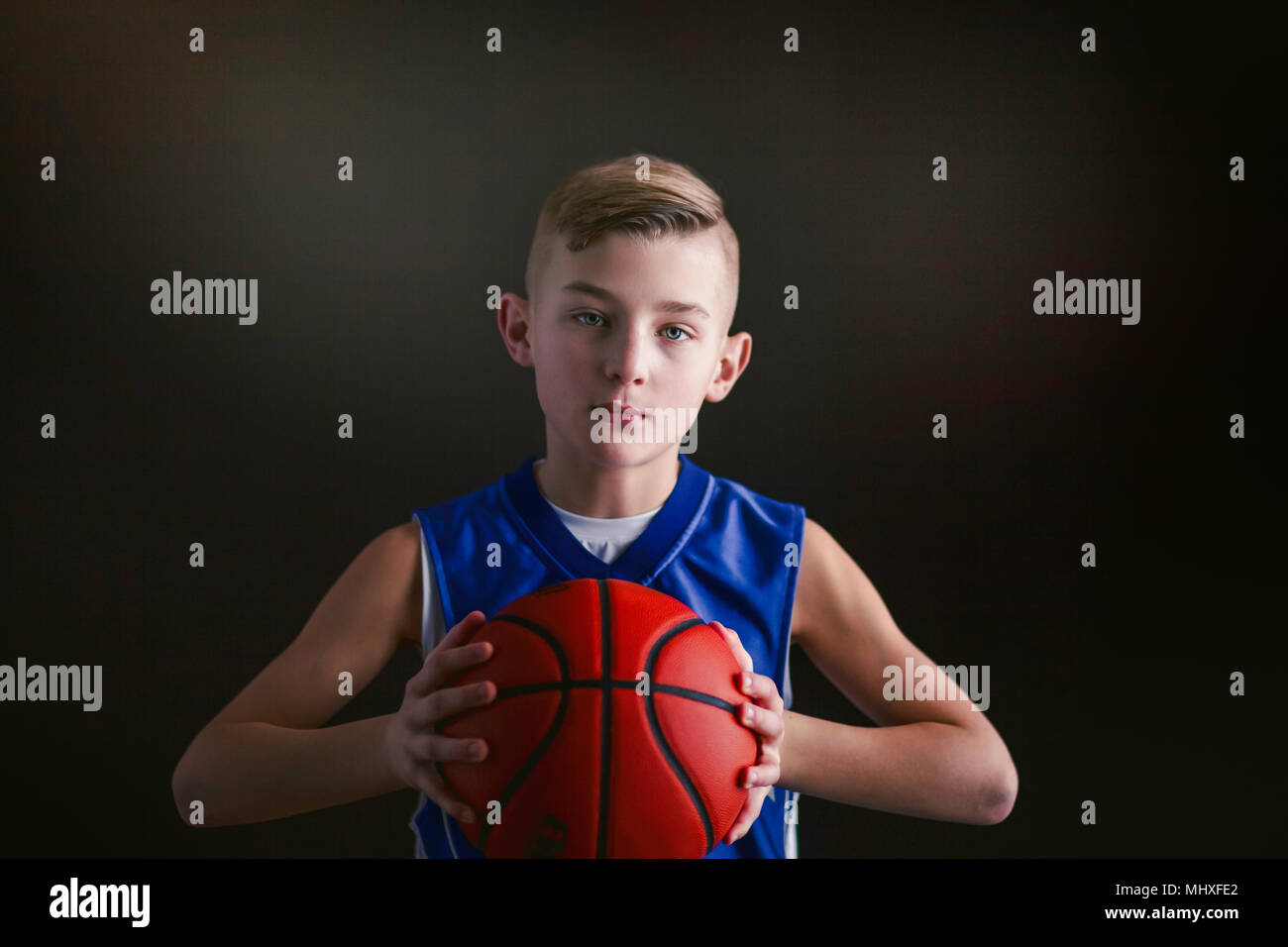 Boy holding basketball Stock Photo - Alamy