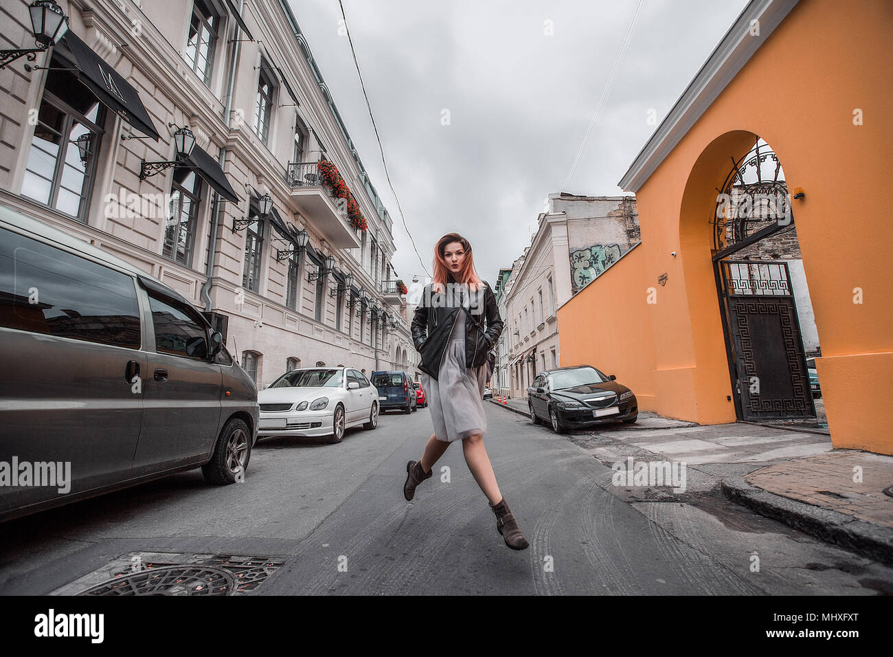 Woman skipping in street Stock Photo - Alamy