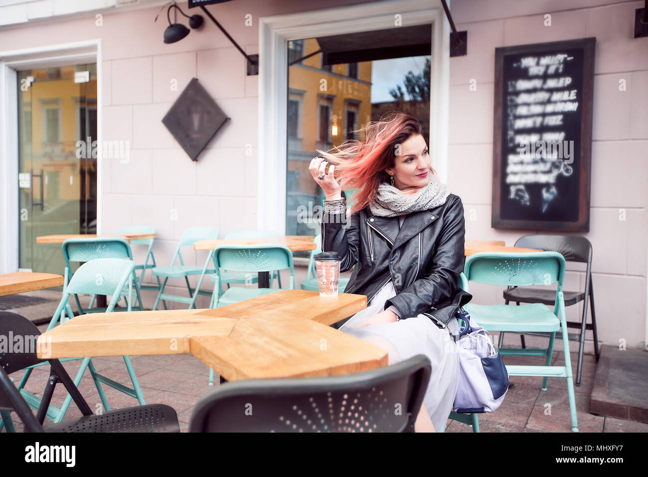 Woman sitting at a cafe table hi-res stock photography and images - Alamy