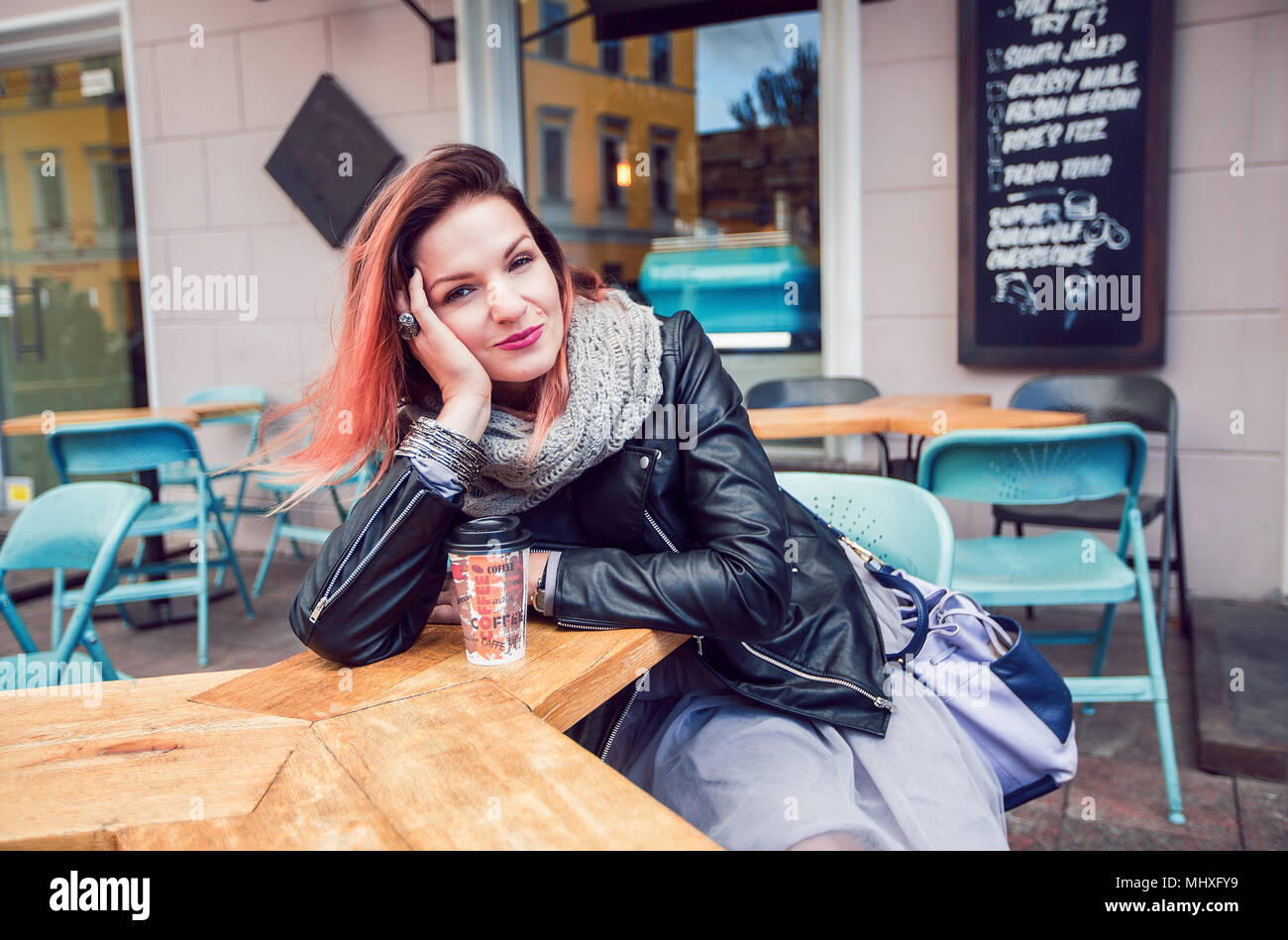 Woman sitting at a cafe table hi-res stock photography and images - Alamy