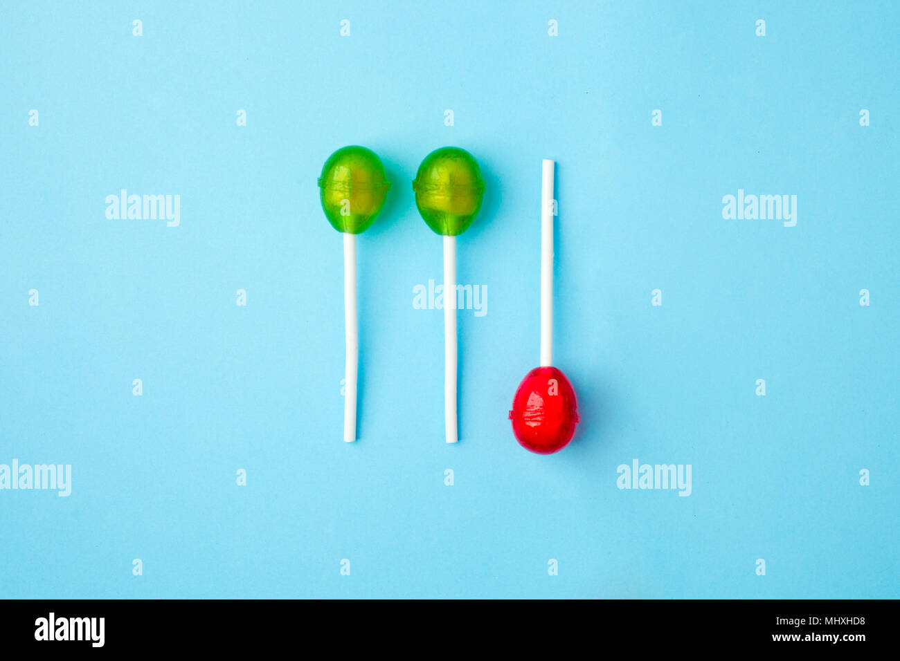 Lollipop flat lay minimal concept, three round lollipops are luing on ...
