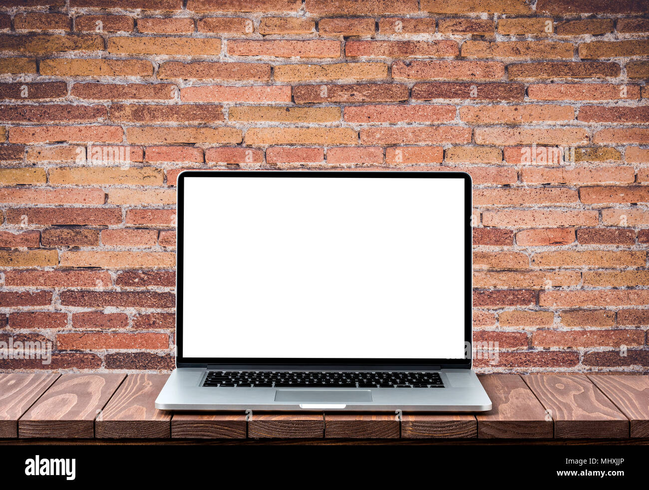Modern laptop with empty white screen on wooden table against blurred ...