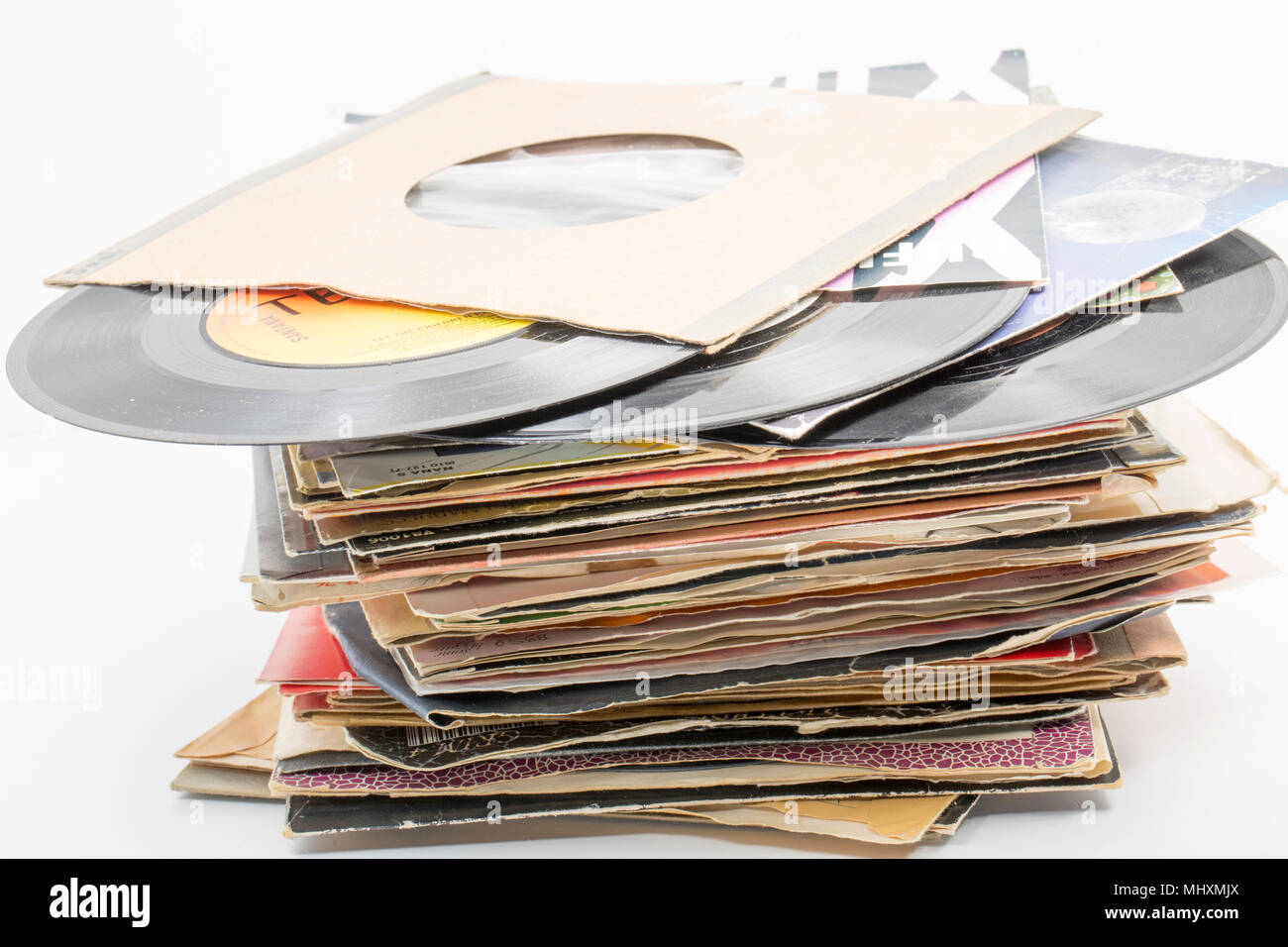 A stack of seven inch 45rpm vinyl singles mostly with songs from the ...