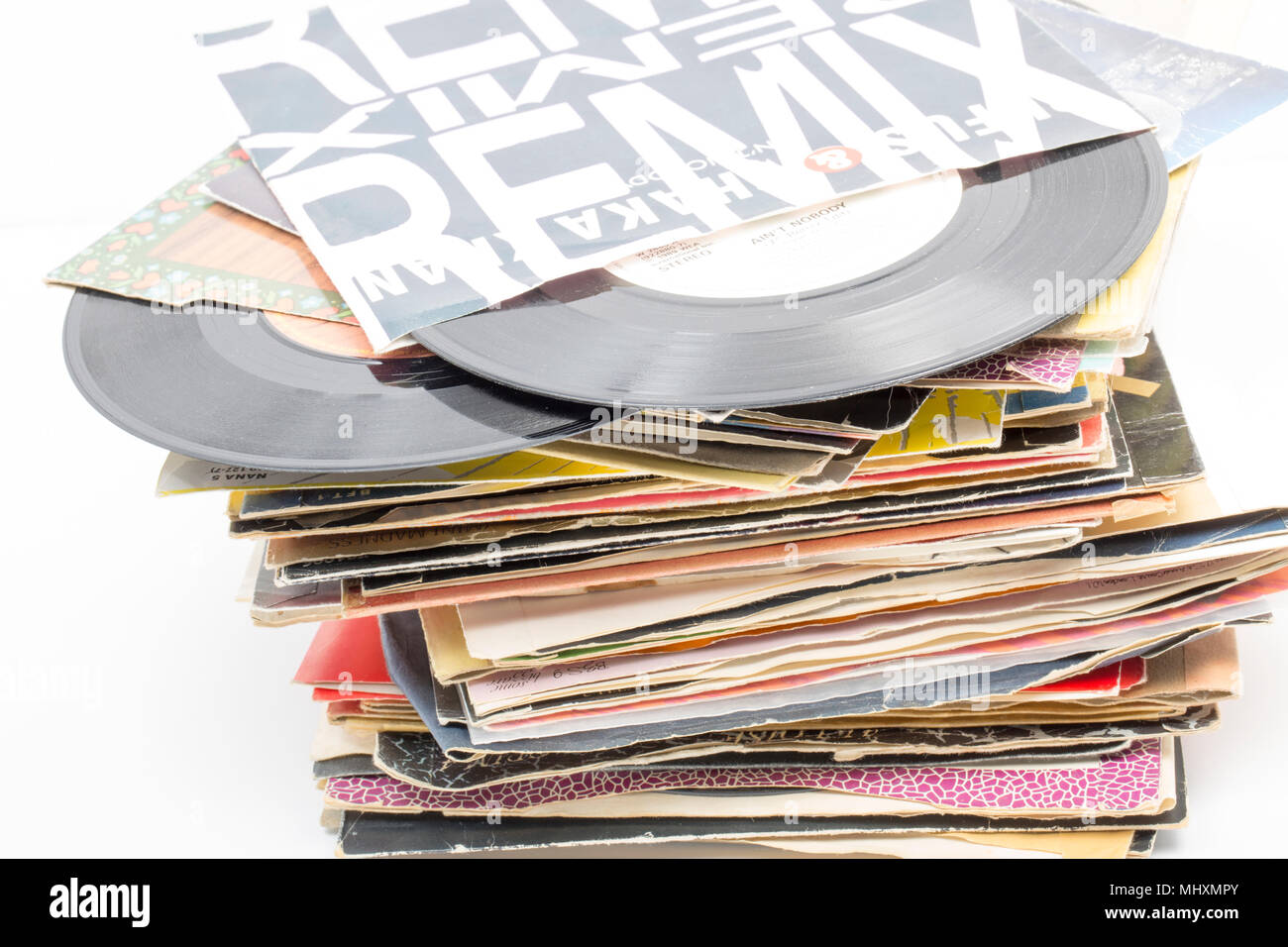 A stack of seven inch 45rpm vinyl singles mostly with songs from the ...