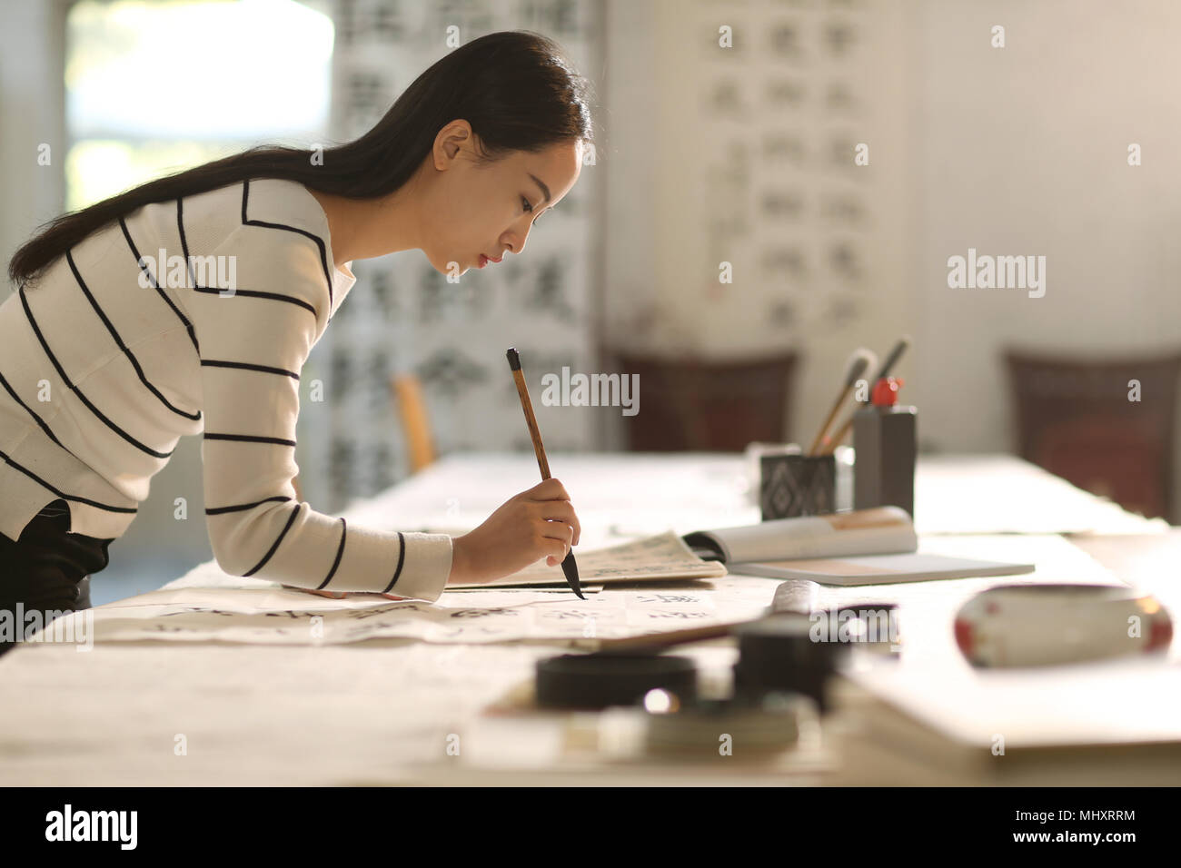 Young women to learn calligraphy Stock Photo - Alamy