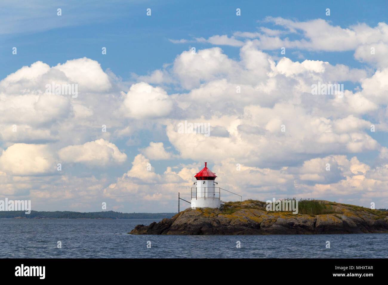A lighthouse in the baltic on a typical scandinavian half sunny day ...