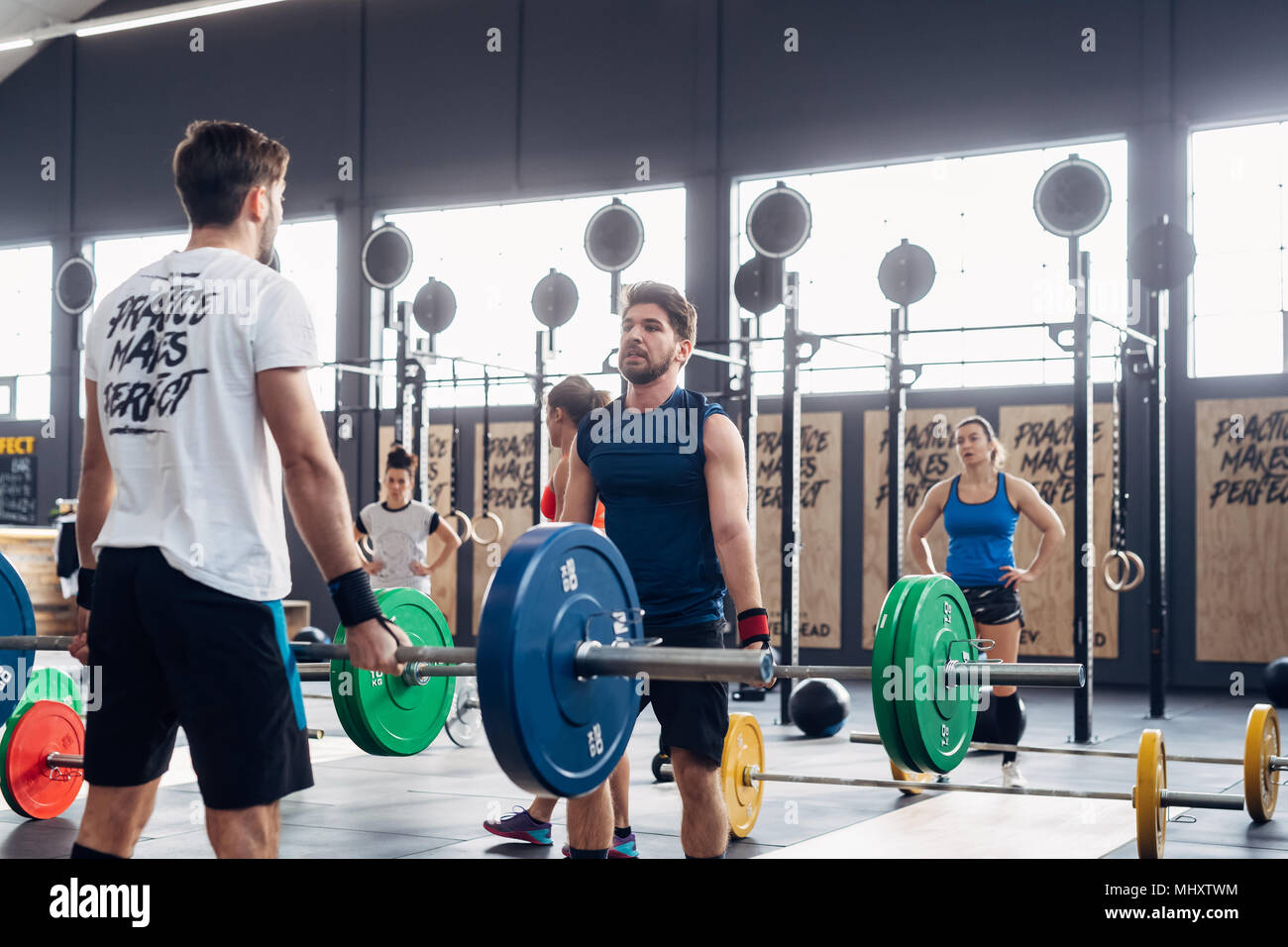 Men weightlifting with barbells in gym Stock Photo - Alamy