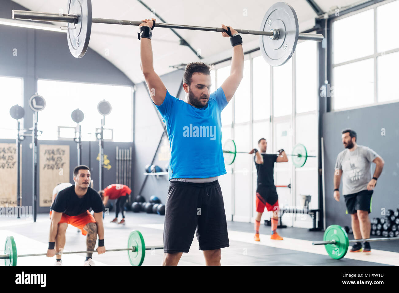 Man weightlifting barbell in gym Stock Photo - Alamy